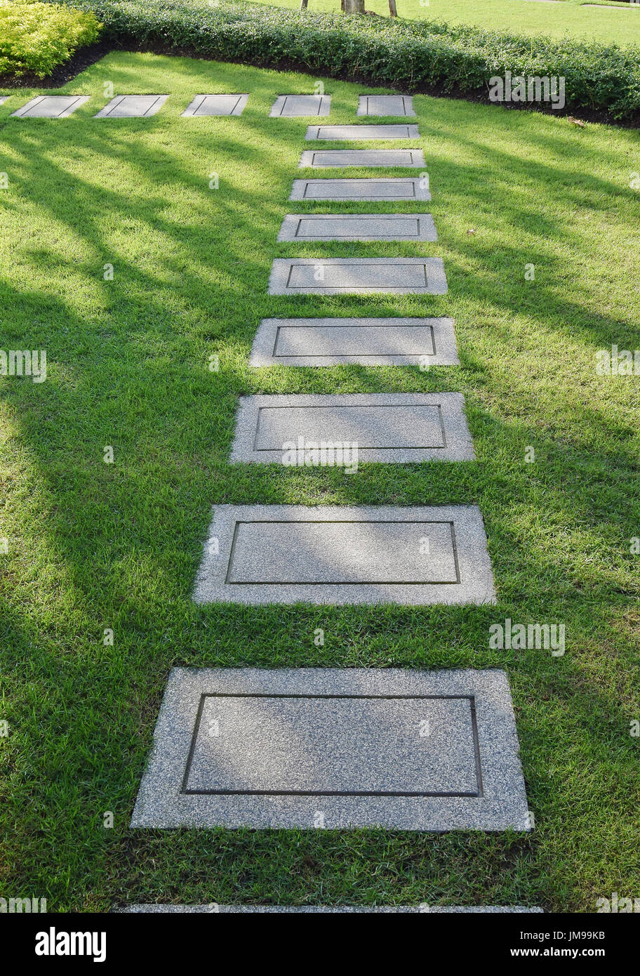 L shape of gravel pathway on green field as background Stock Photo - Alamy
