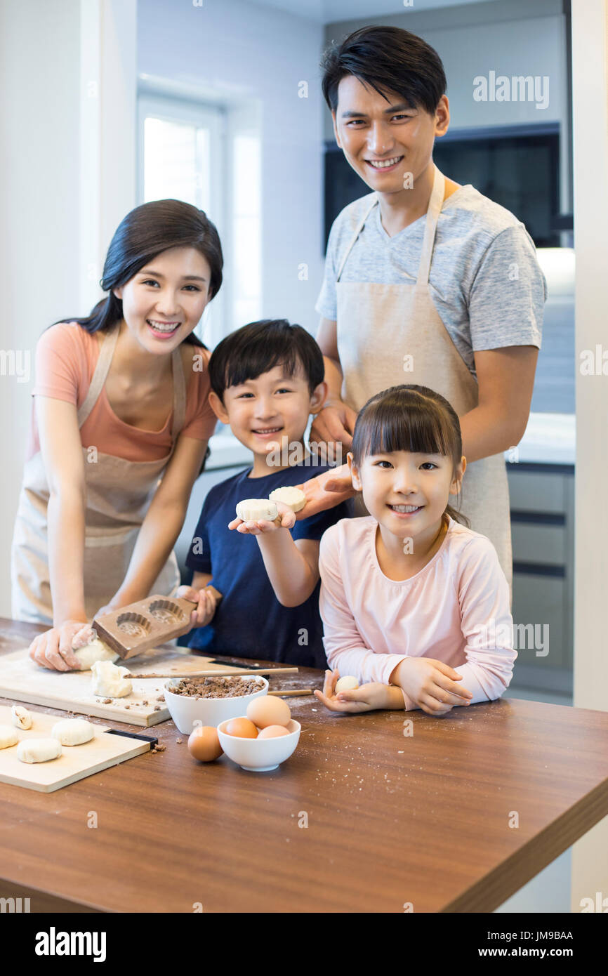 Happy young Chinese family baking together Stock Photo - Alamy