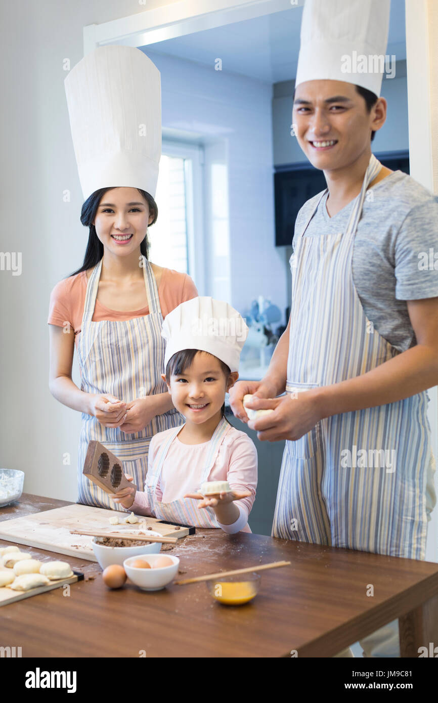 Happy young Chinese family baking together Stock Photo - Alamy