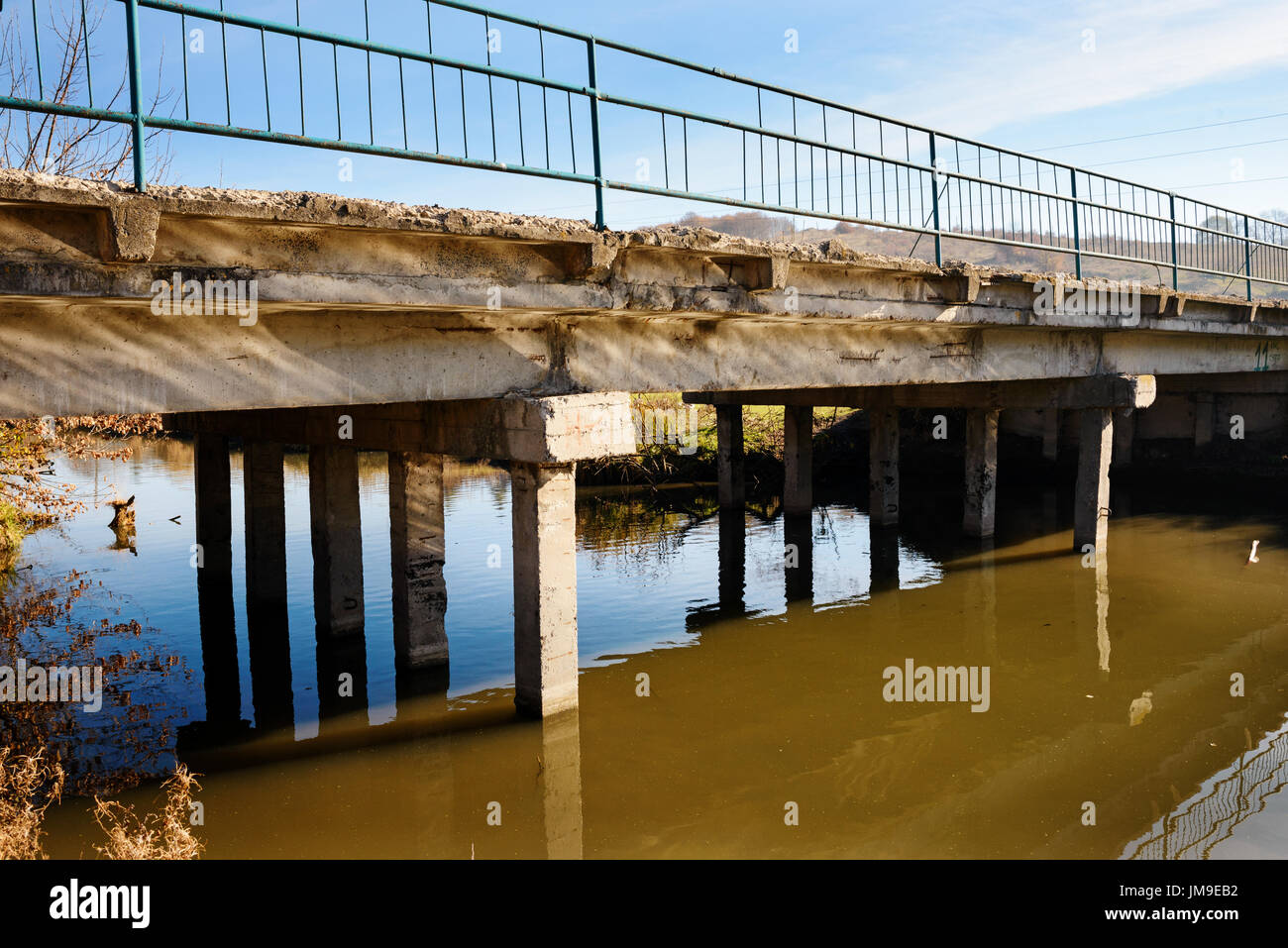View of the neglected old bridge that consists of concrete slabs ...