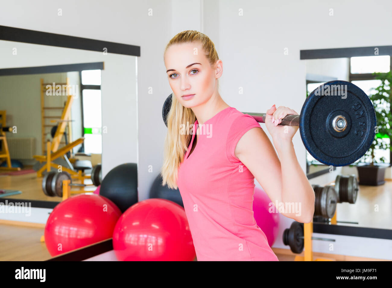 Woman lifting weight bar in hi-res stock photography and images - Alamy
