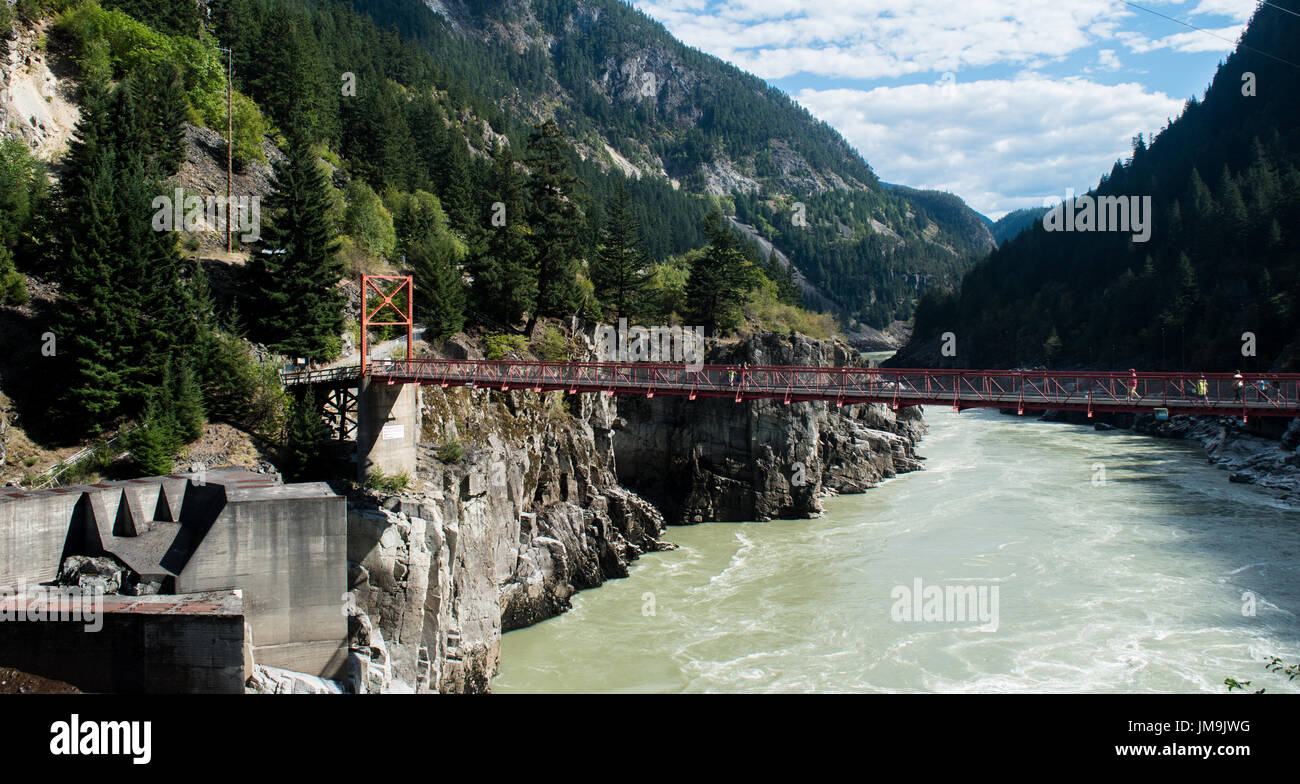 Red bridge connecting two canyons at Hell's Gate, British Columbia on a ...