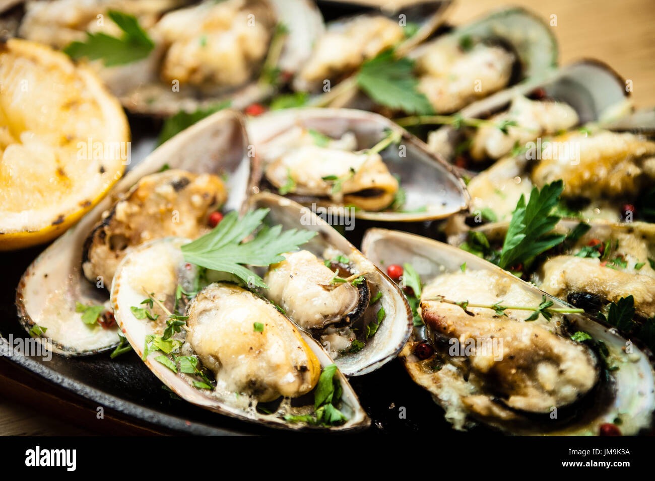 Baked mussels with cheese Stock Photo - Alamy