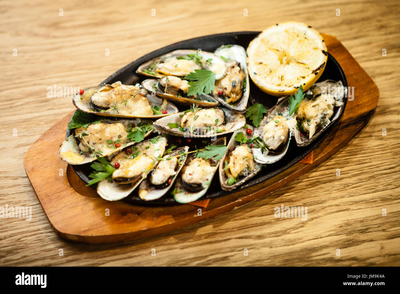Baked mussels with cheese Stock Photo - Alamy
