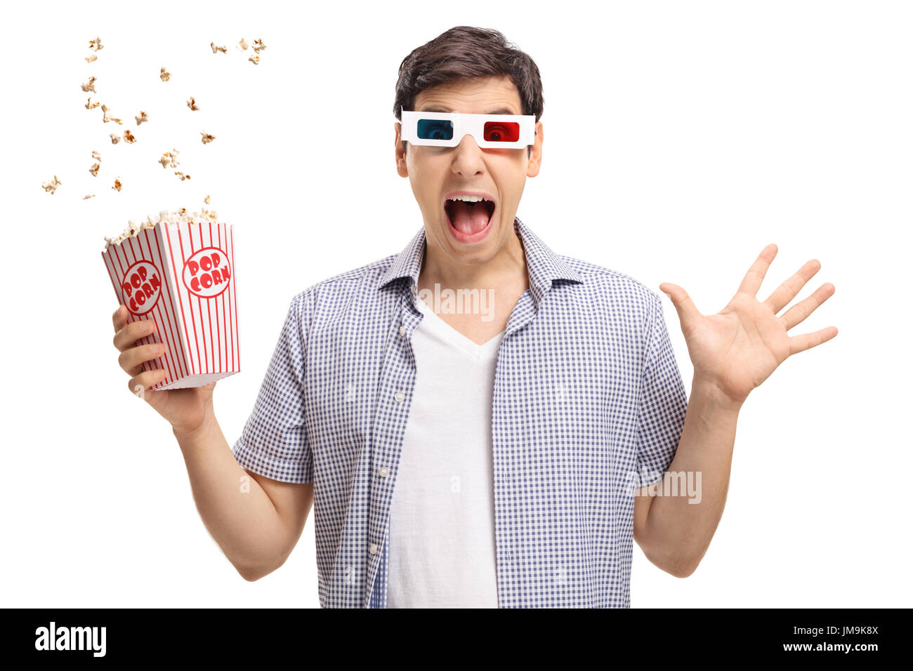 Terrified guy with a pair of 3D glasses and popcorn isolated on white ...