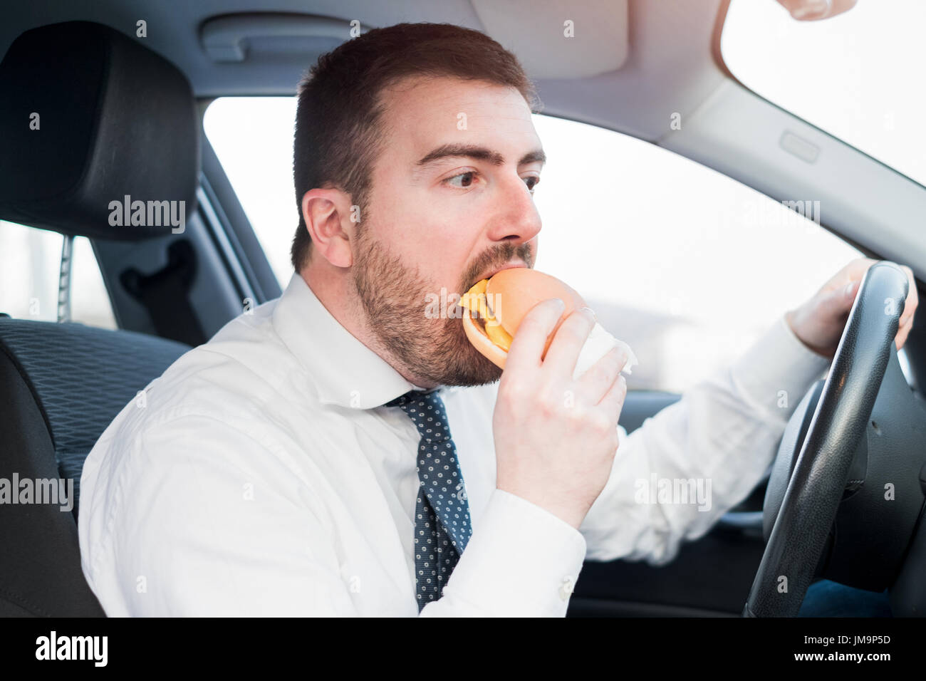 Man eating burger hurry hi-res stock photography and images - Alamy