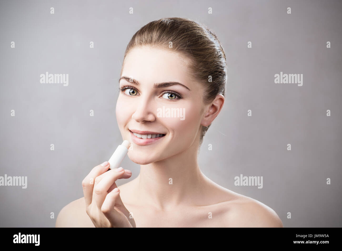 Beautiful woman applying hygienic lip balm. Lipcare Stick. Lips Skin ...