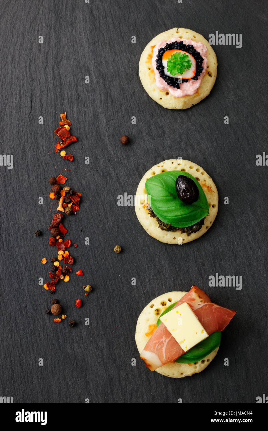 Homemade pancake canapes on slate stone plate for finger food party ...