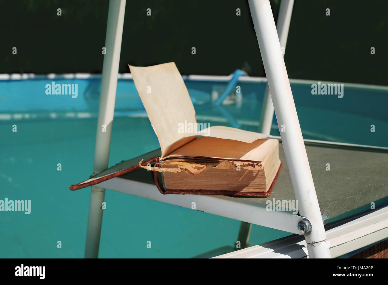 Book Near Swimming Pool Stock Photo - Alamy