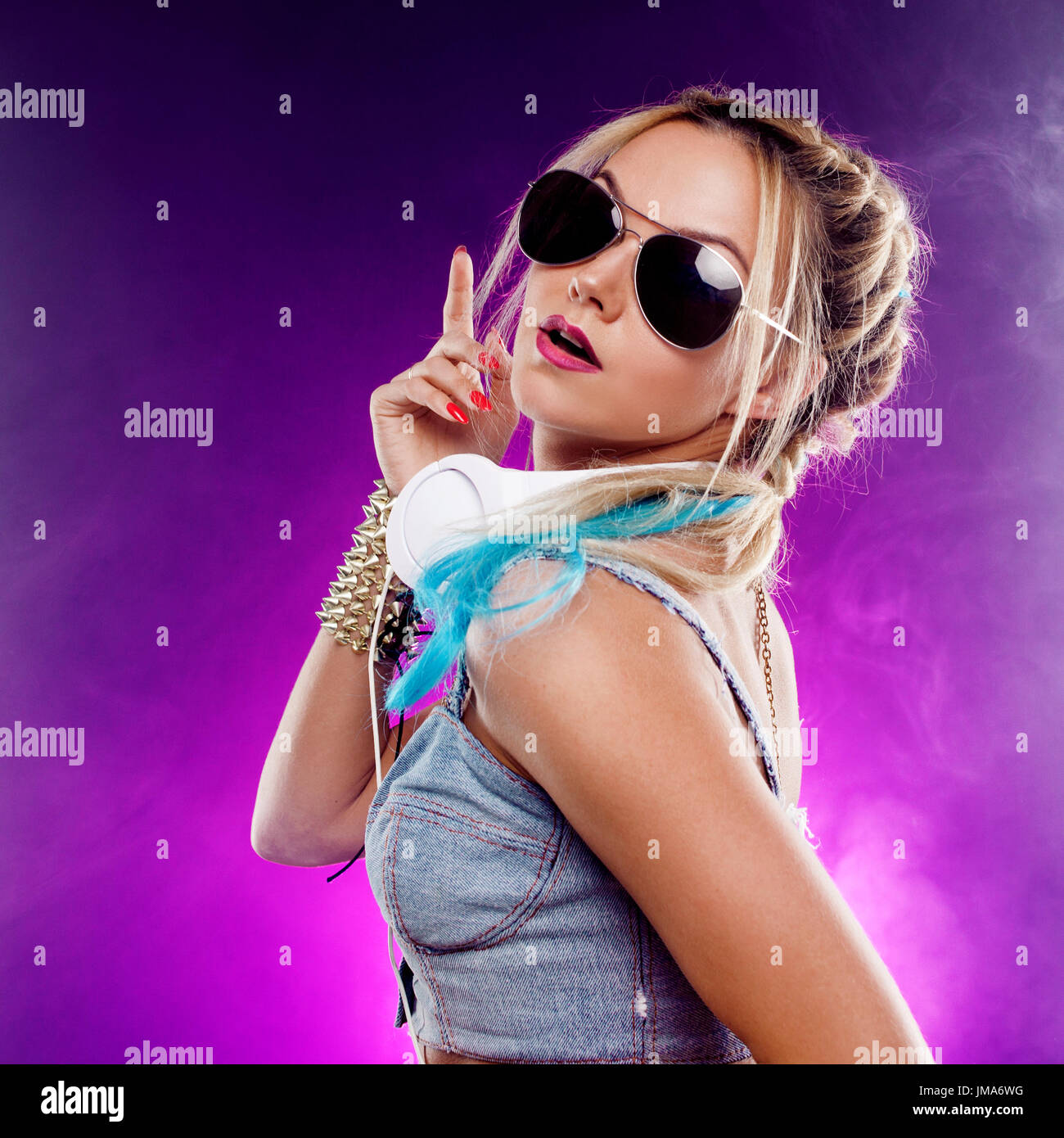 Young fashionable girl in disco style. Listening music and enjoying ...