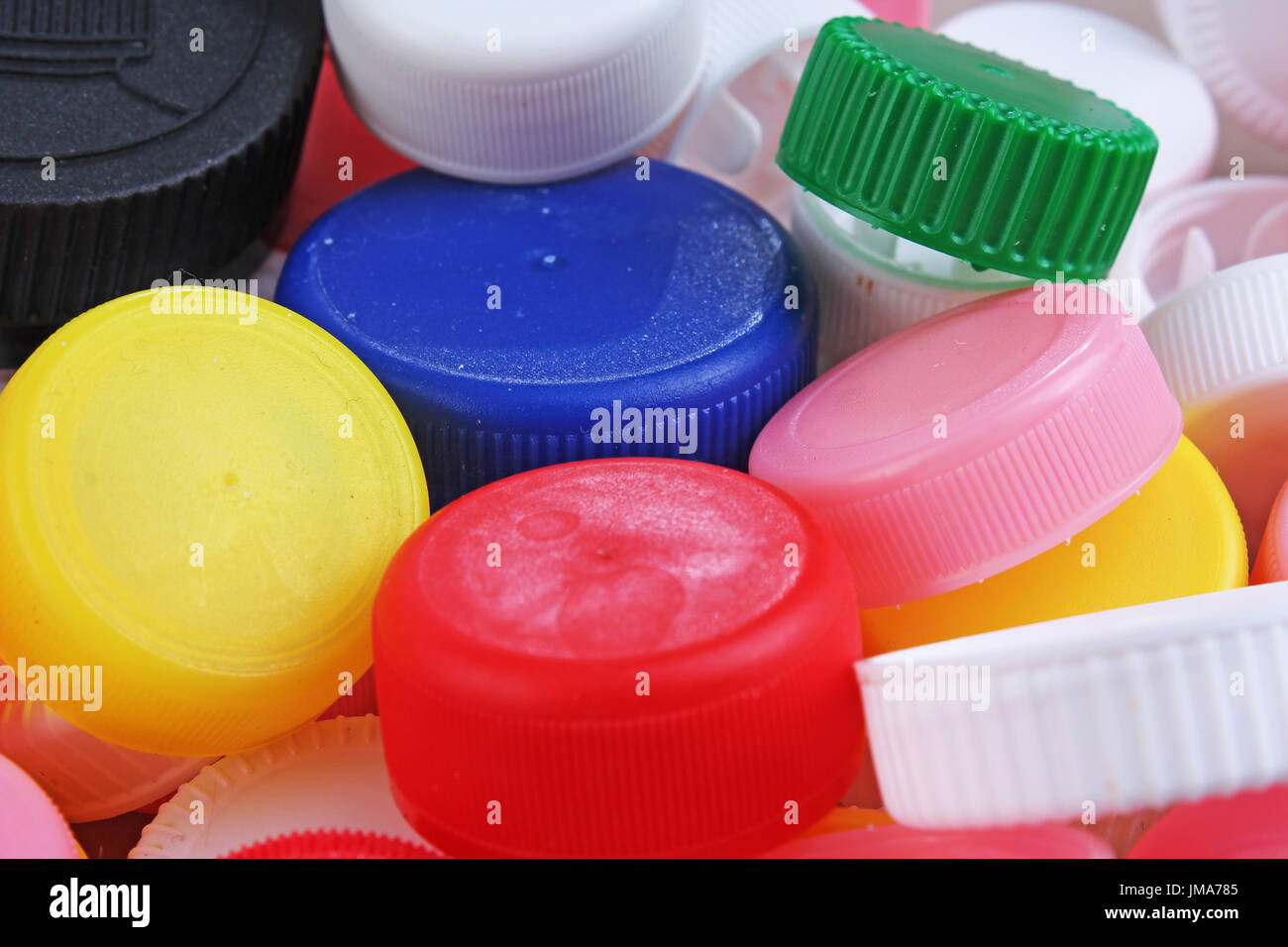 Collect plastic bottle caps. Close-up shot of stack of recyclable ...