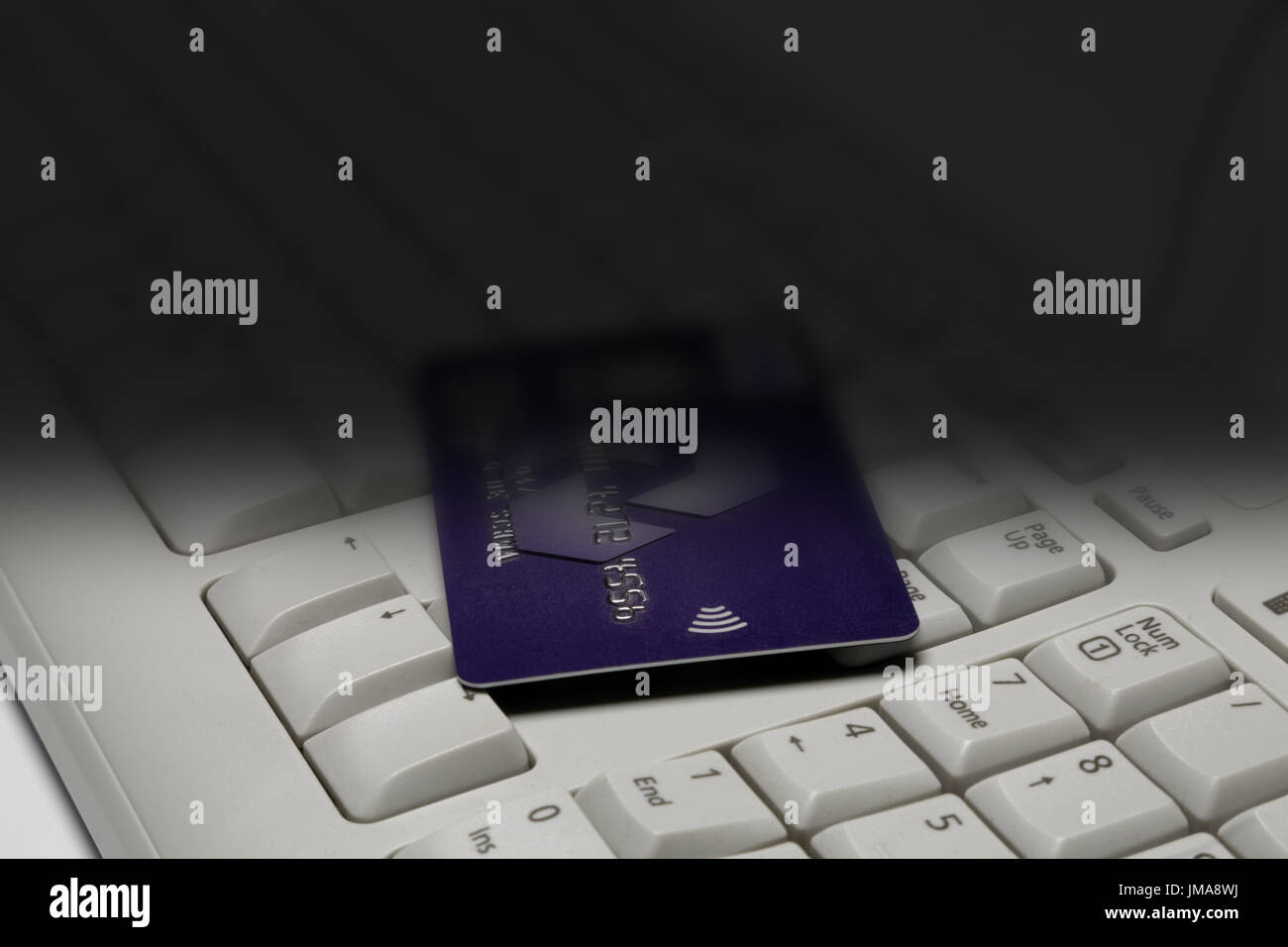 Debit card on keyboard Stock Photo - Alamy