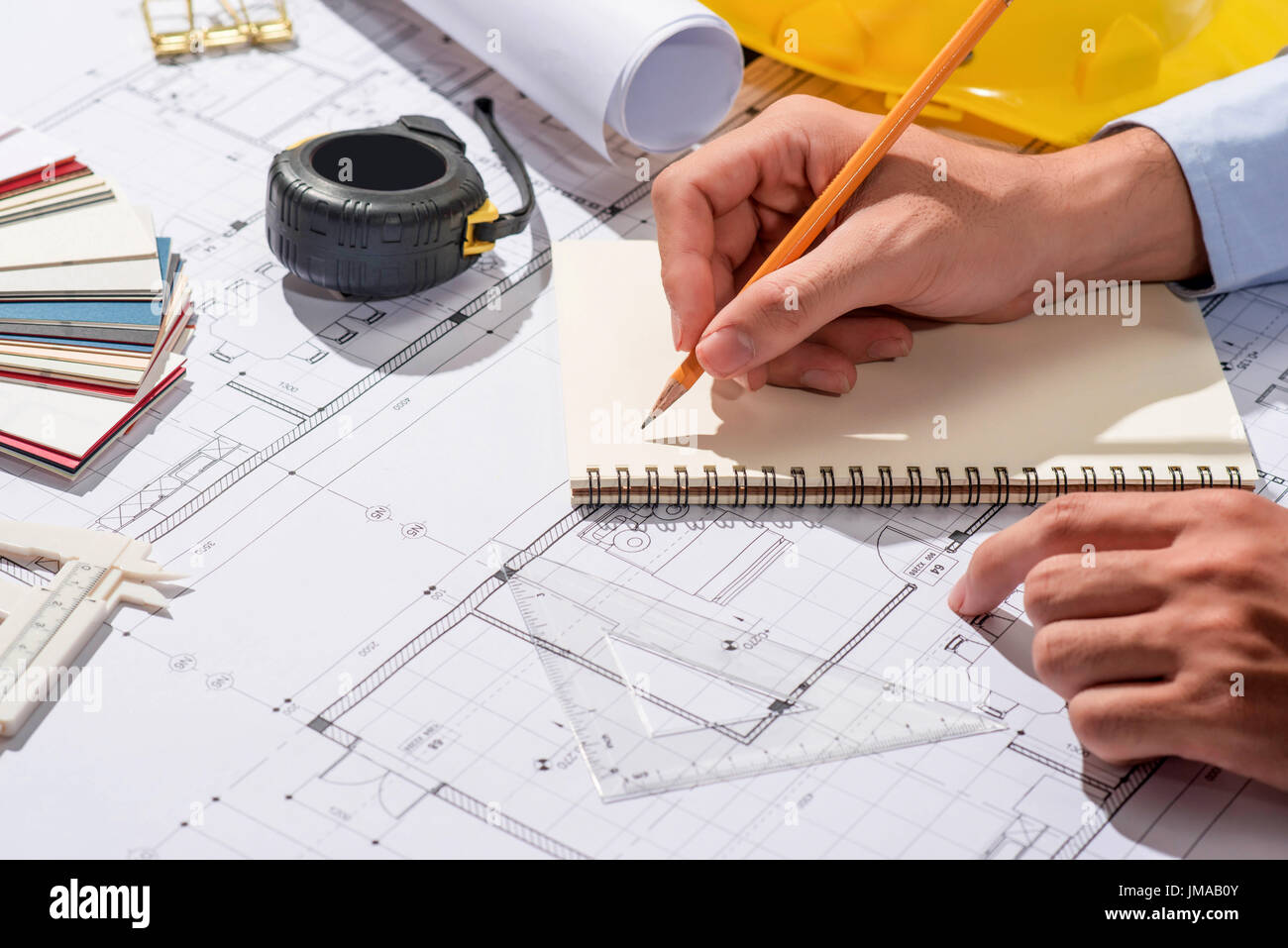 Working on blueprints. Construction project with hands writing on ...