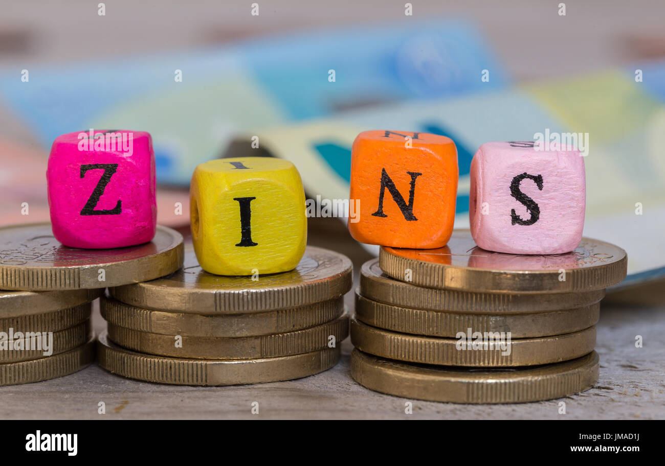 Zins (in german Interest) alphabet cube on coins concept Stock Photo ...