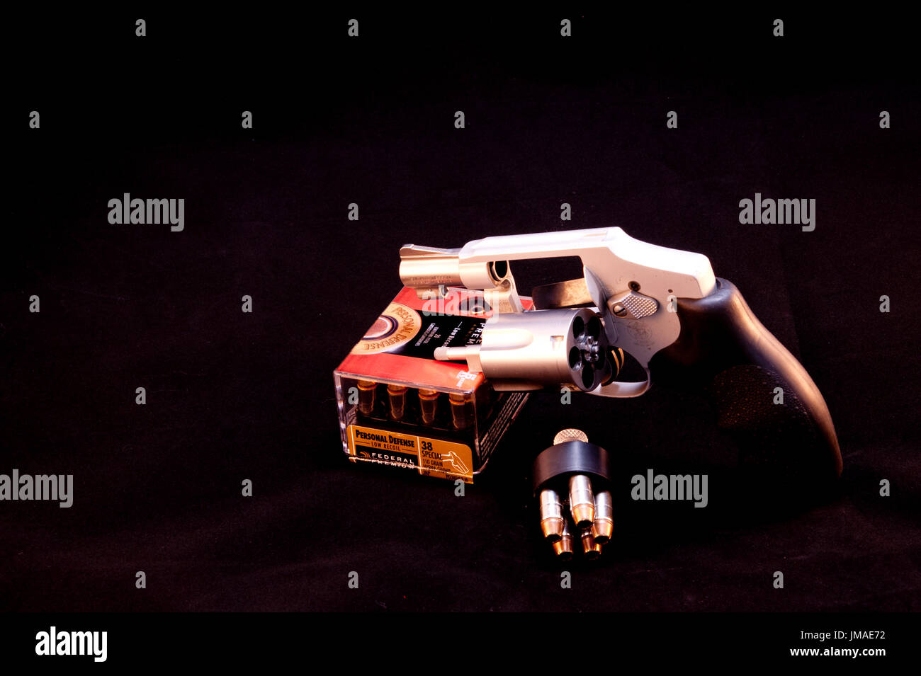 38 Special Revolver with a speed loader laying beside the gun along ...