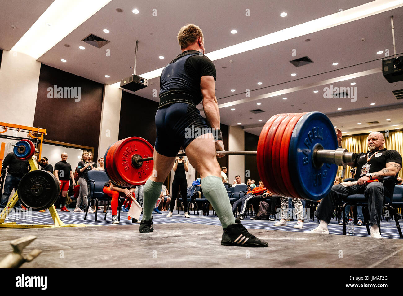 male powerlifter attempt a deadlift in sports gym during Сhampionship ...