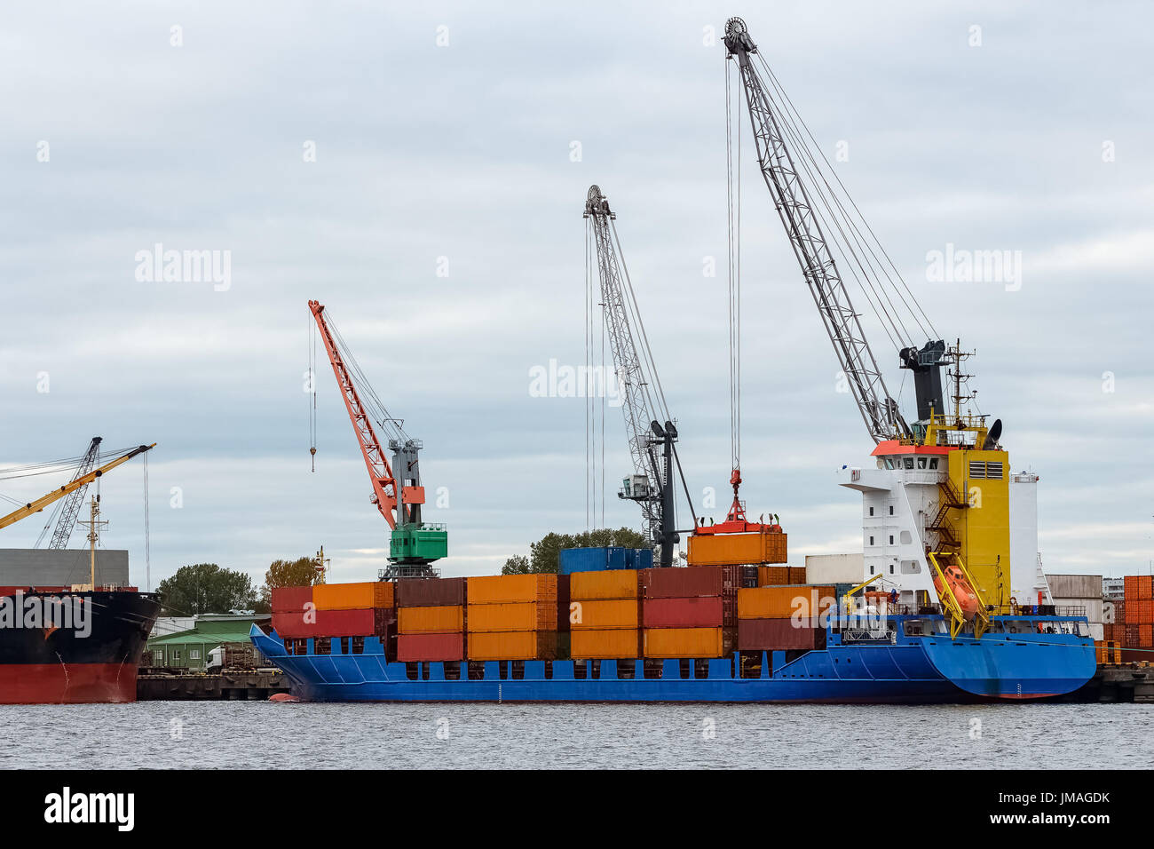 Blue container ship loading in cargo port of Europe Stock Photo - Alamy