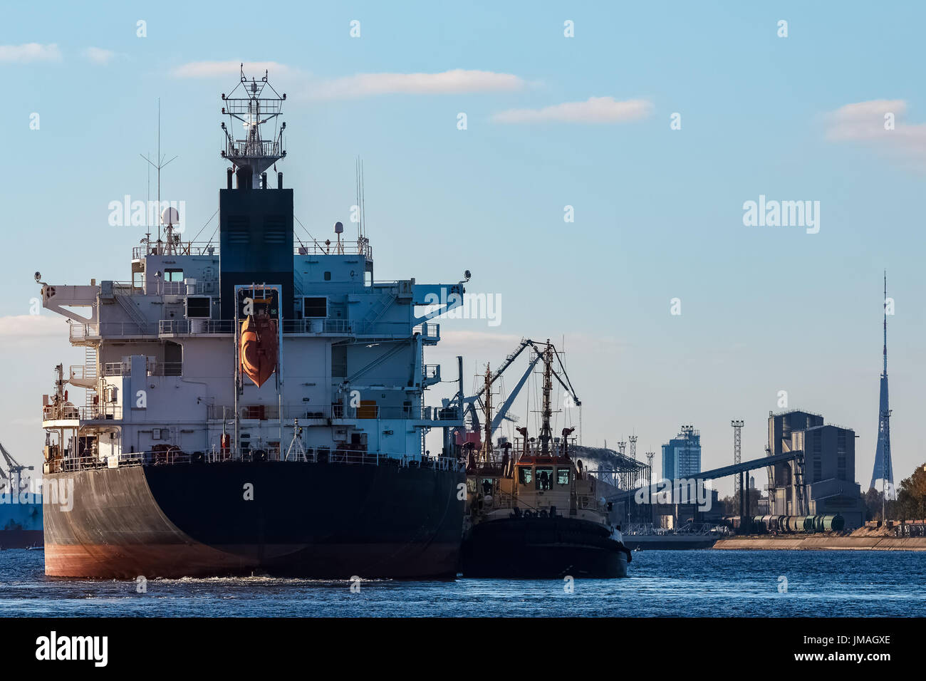 Black cargo ship entering the port of Riga, Europe Stock Photo - Alamy
