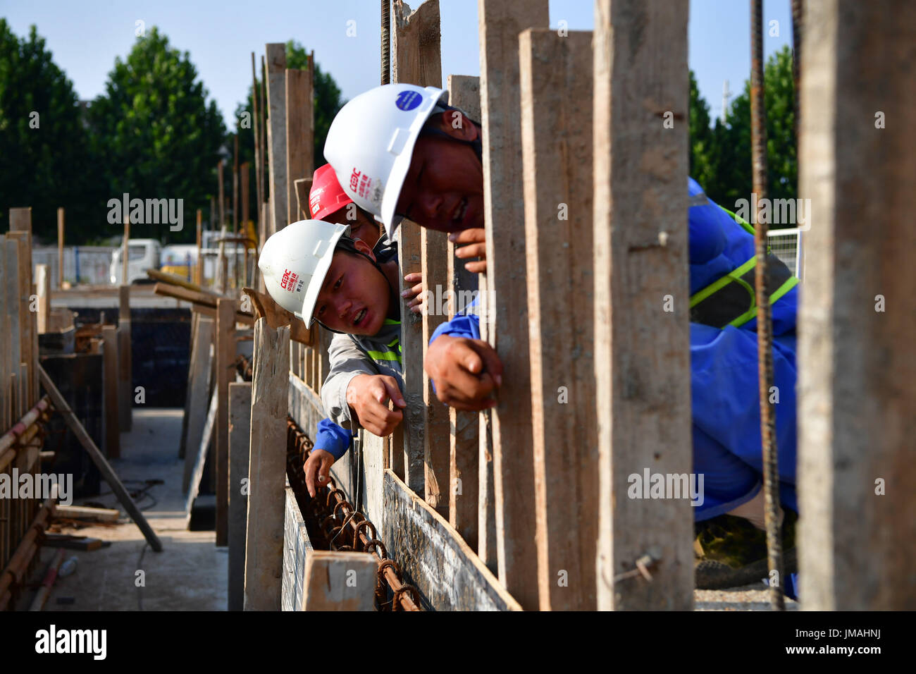 Zhoukou, China's Henan Province. 26th July, 2017. Workers are seen ...