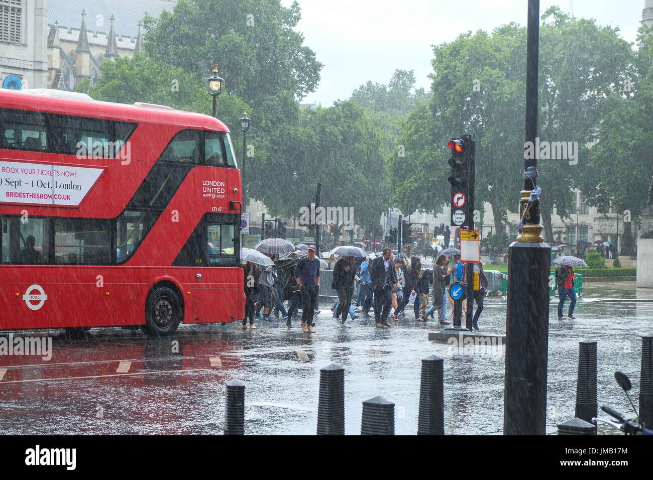 London, UK. 27th July, 2017. Heavy rain shower in Parliament Square ...