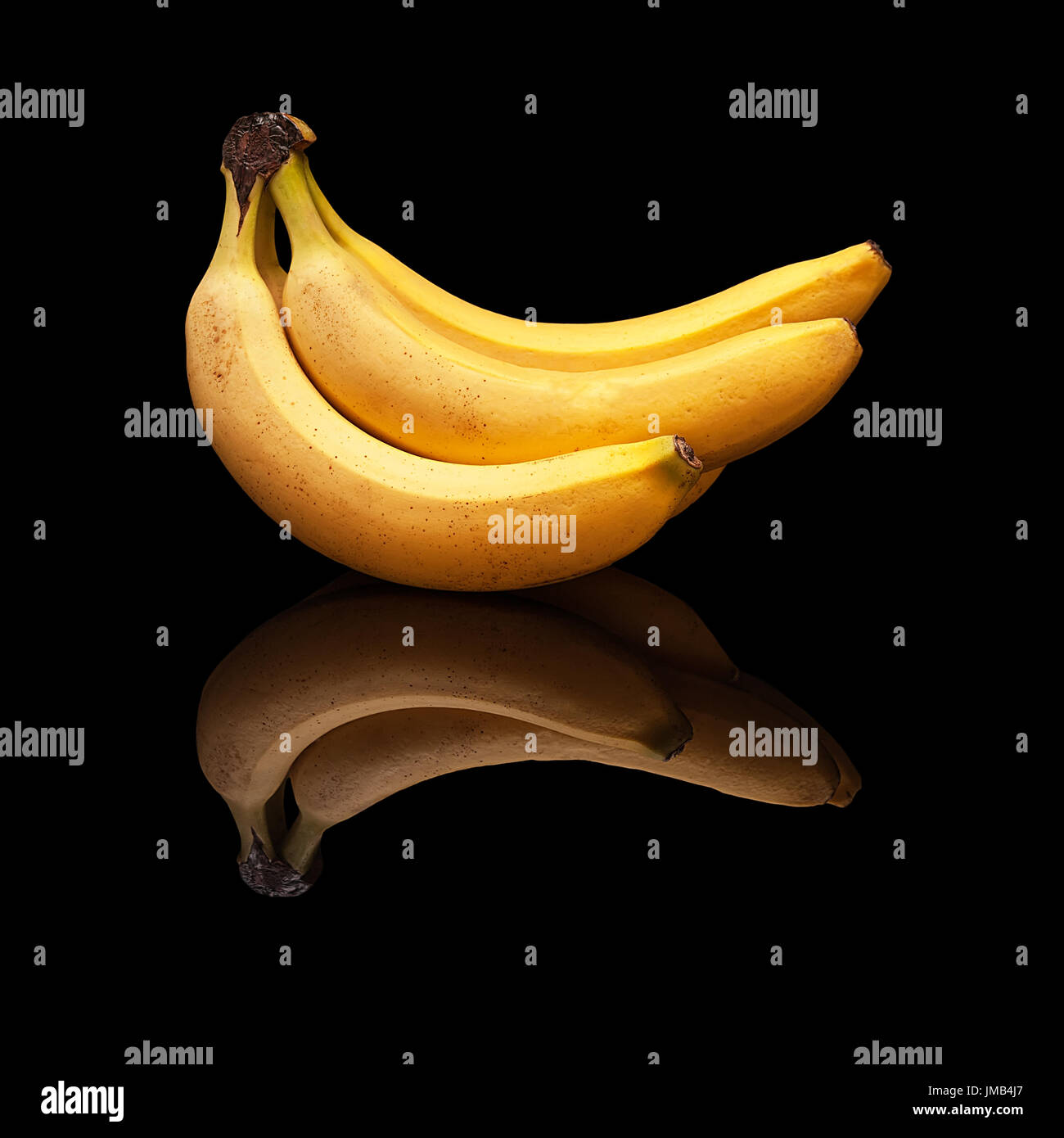 Bunch of ripe bananas with real reflection on a black background ...