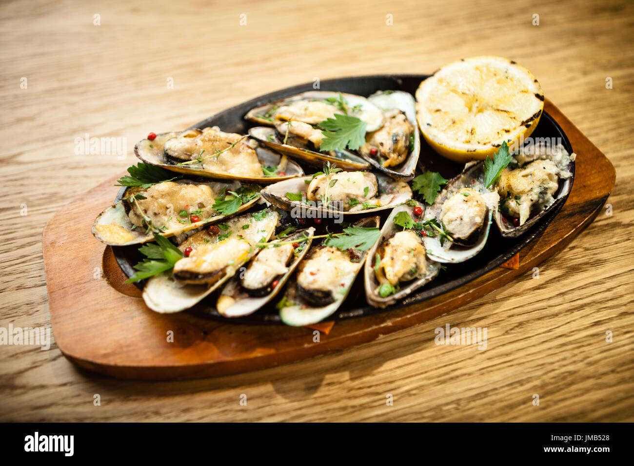 Baked mussels with cheese Stock Photo - Alamy