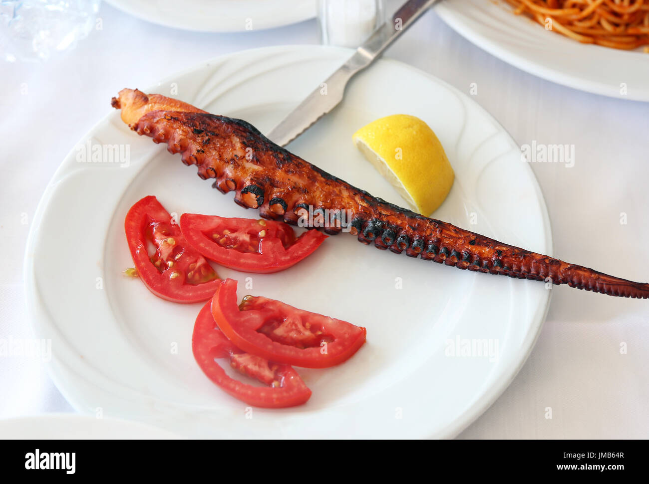 roasted octopus at a greek tavern Stock Photo - Alamy