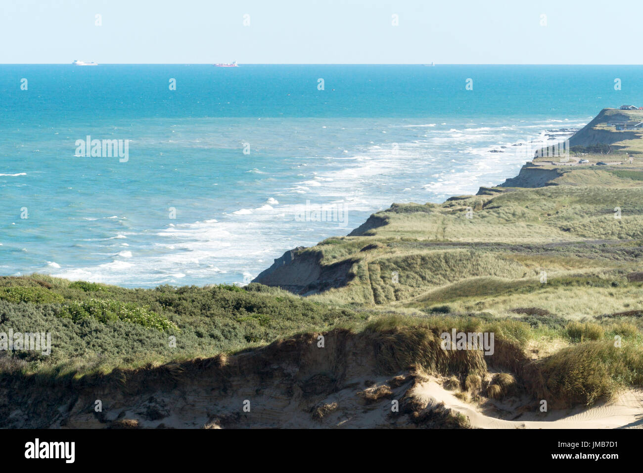 Sunlit sand dunes and wavy sea of rubjerg knude denmark Stock Photo - Alamy