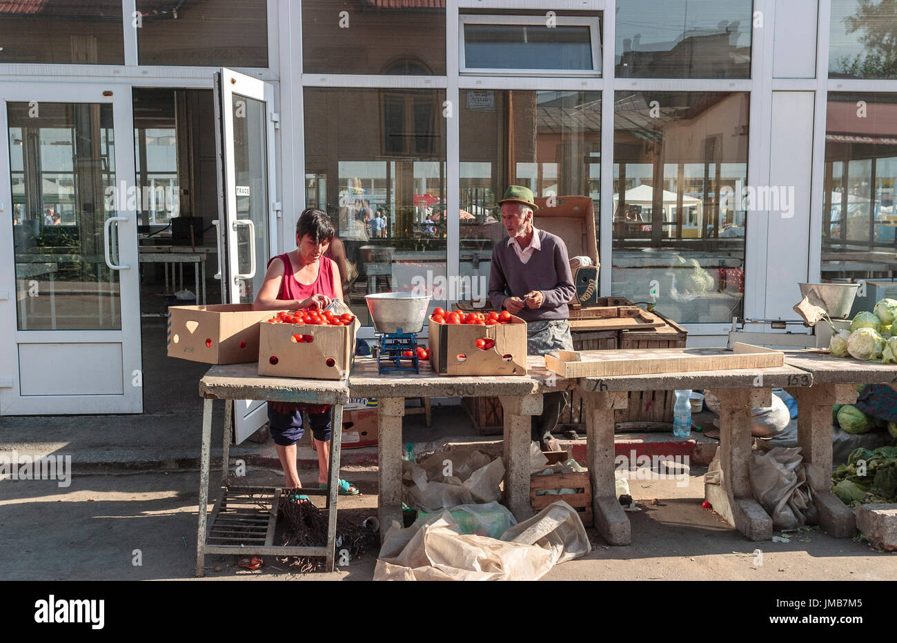 Peasants at the tomatoes booth/ stand on a farmer´s market day, Craiova ...