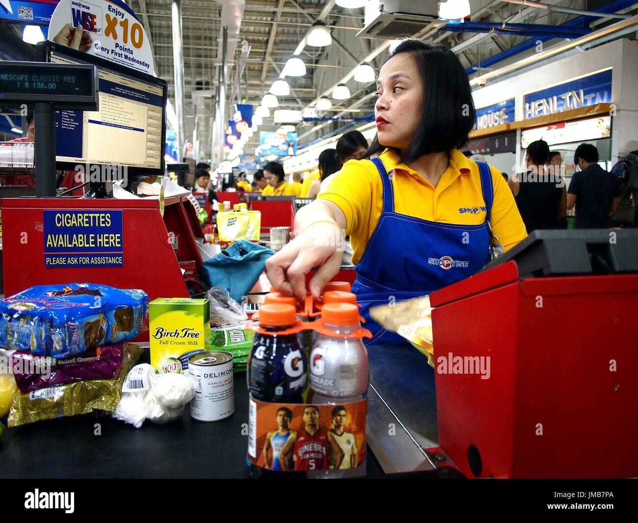 ANTIPOLO CITY, PHILIPPINES - JULY 17, 2017: A cashier scans grocery ...