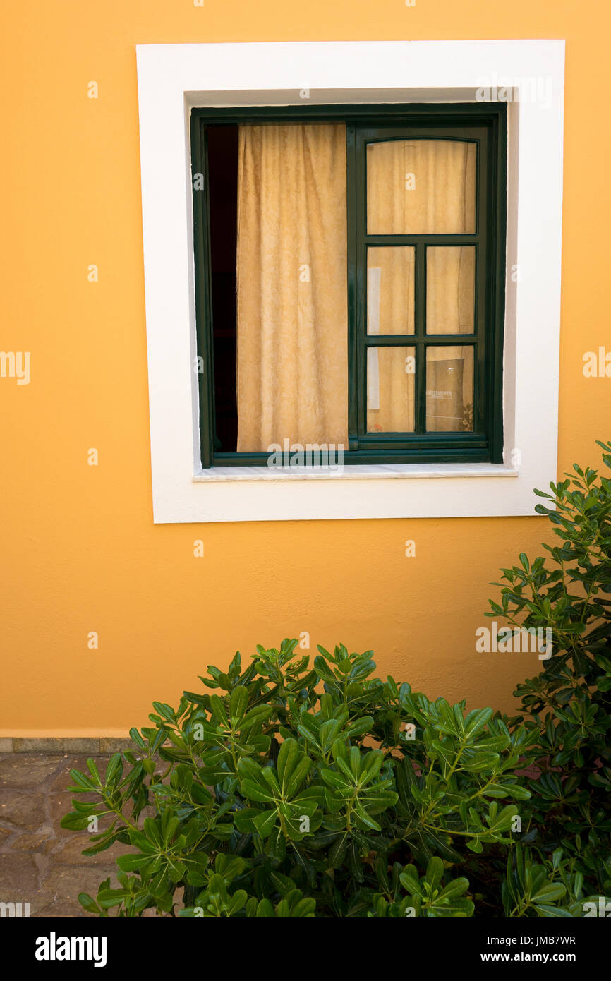 Greek window with curtains shut Stock Photo - Alamy
