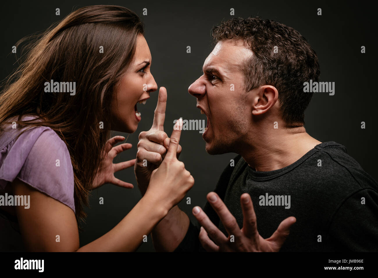 Angry young couple shouting face to face Stock Photo - Alamy