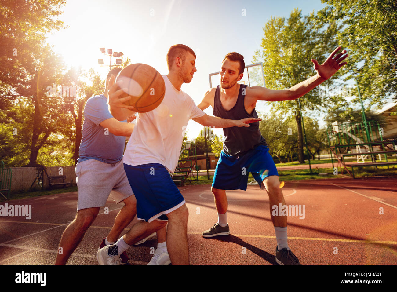 Young basketball players have a training outdoor. They are playing and ...