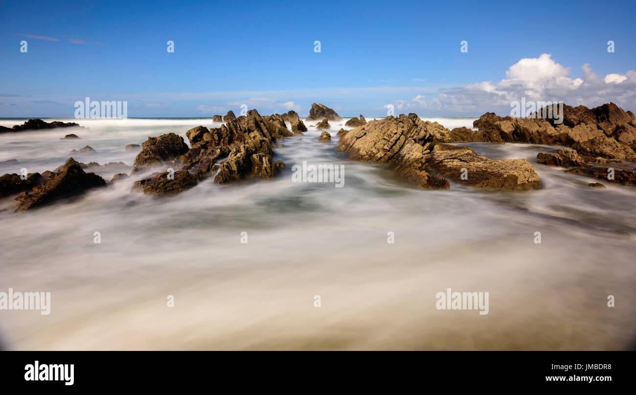Coastal rocks in the ocean long exposure Stock Photo - Alamy