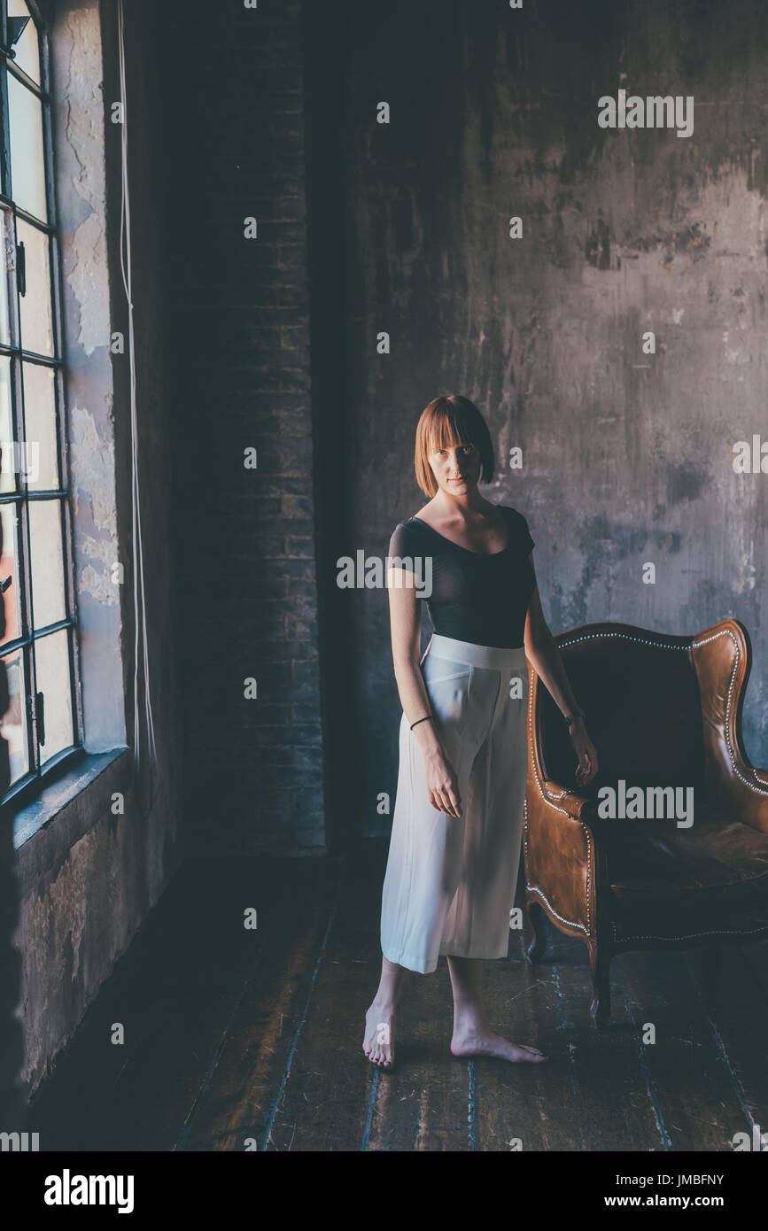 young beautiful woman indoor posing looking camera - fashion, modelling ...