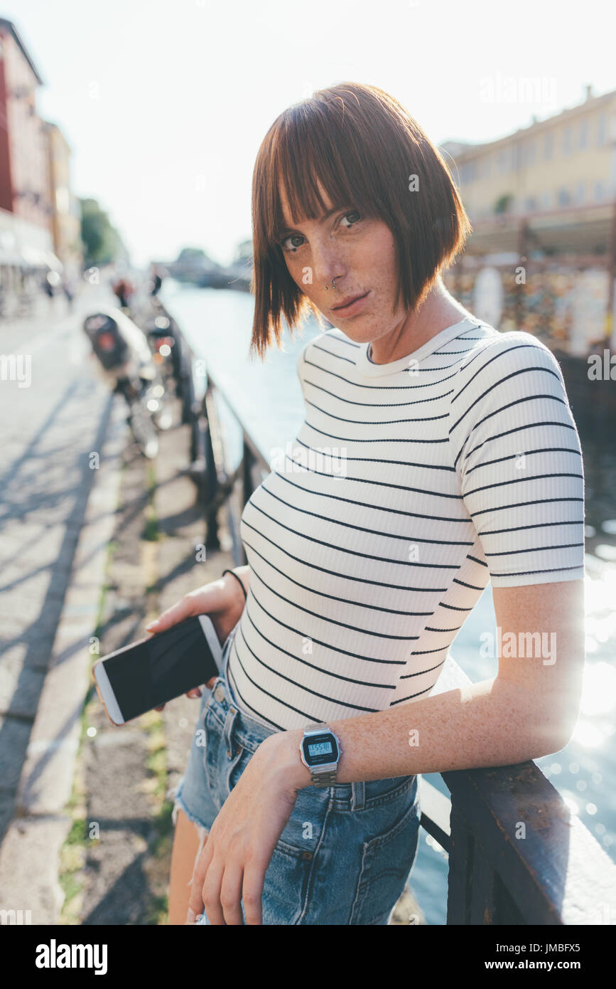 portrait young beautiful woman outdoor posing back light looking camera ...