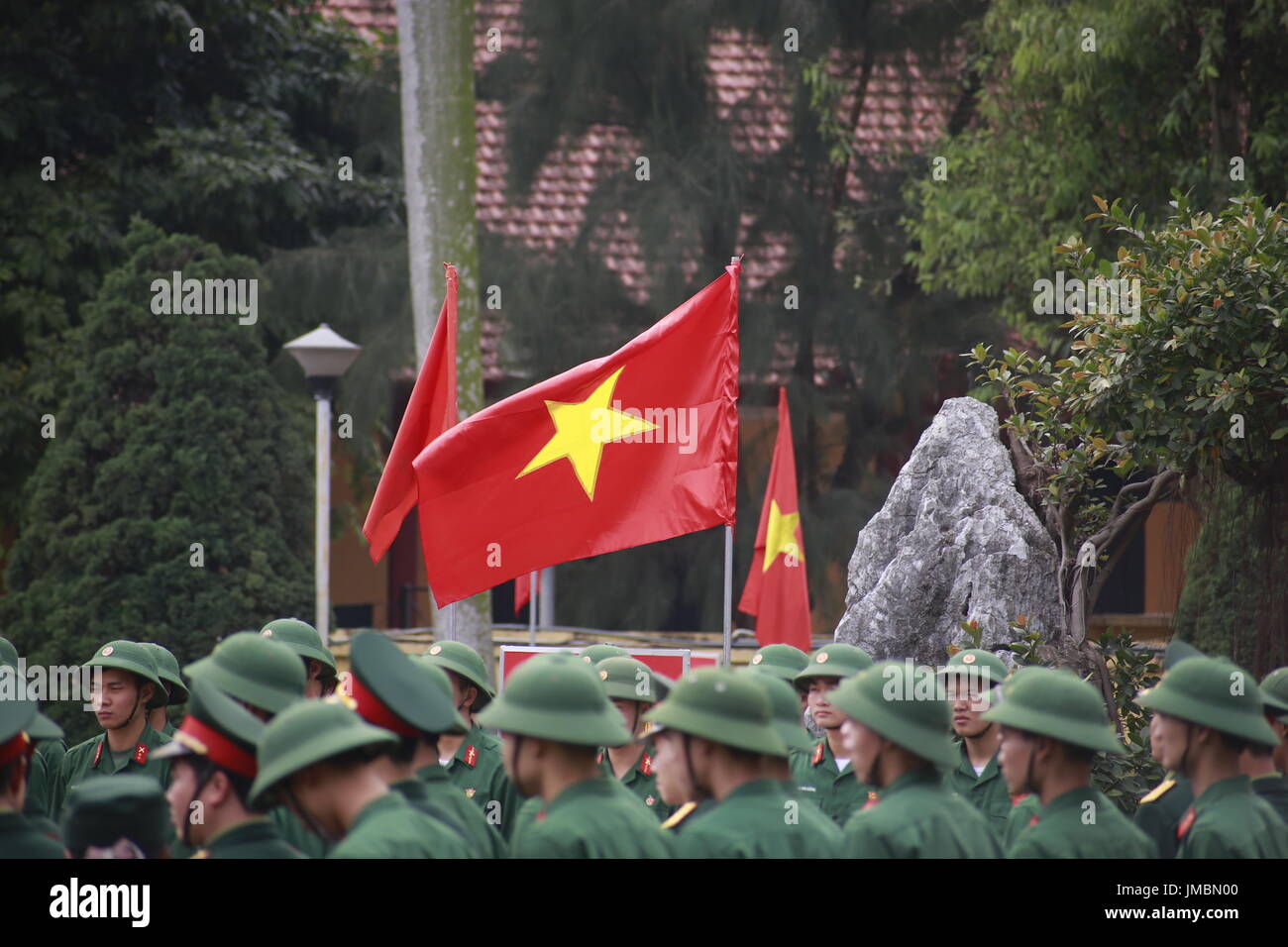 Vietnamese soldiers lined up, with a Vietnamese flag above them, in Ho ...