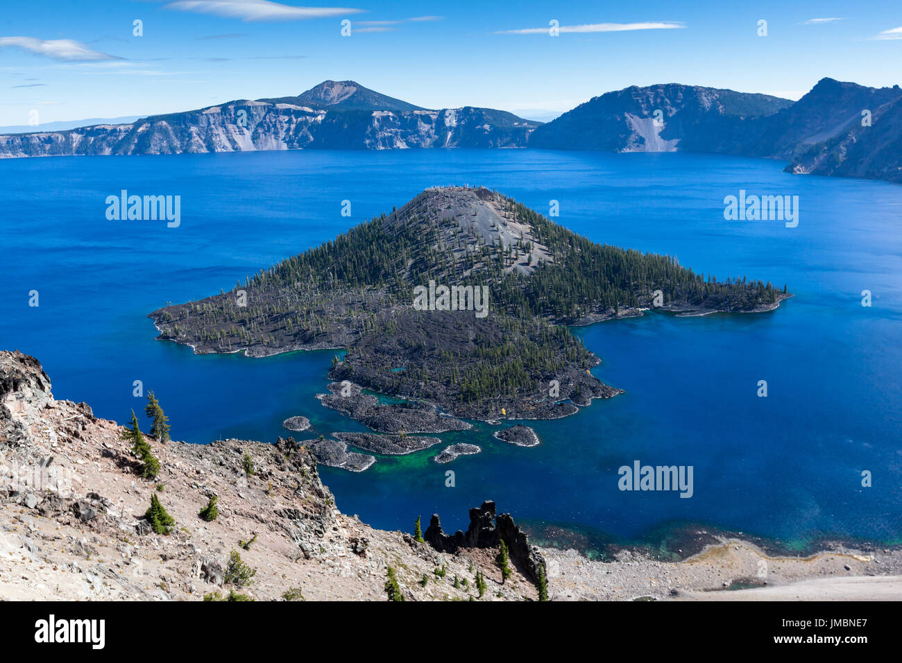 The volcanic cone of Wizard Island with trees growing in the rock and ...