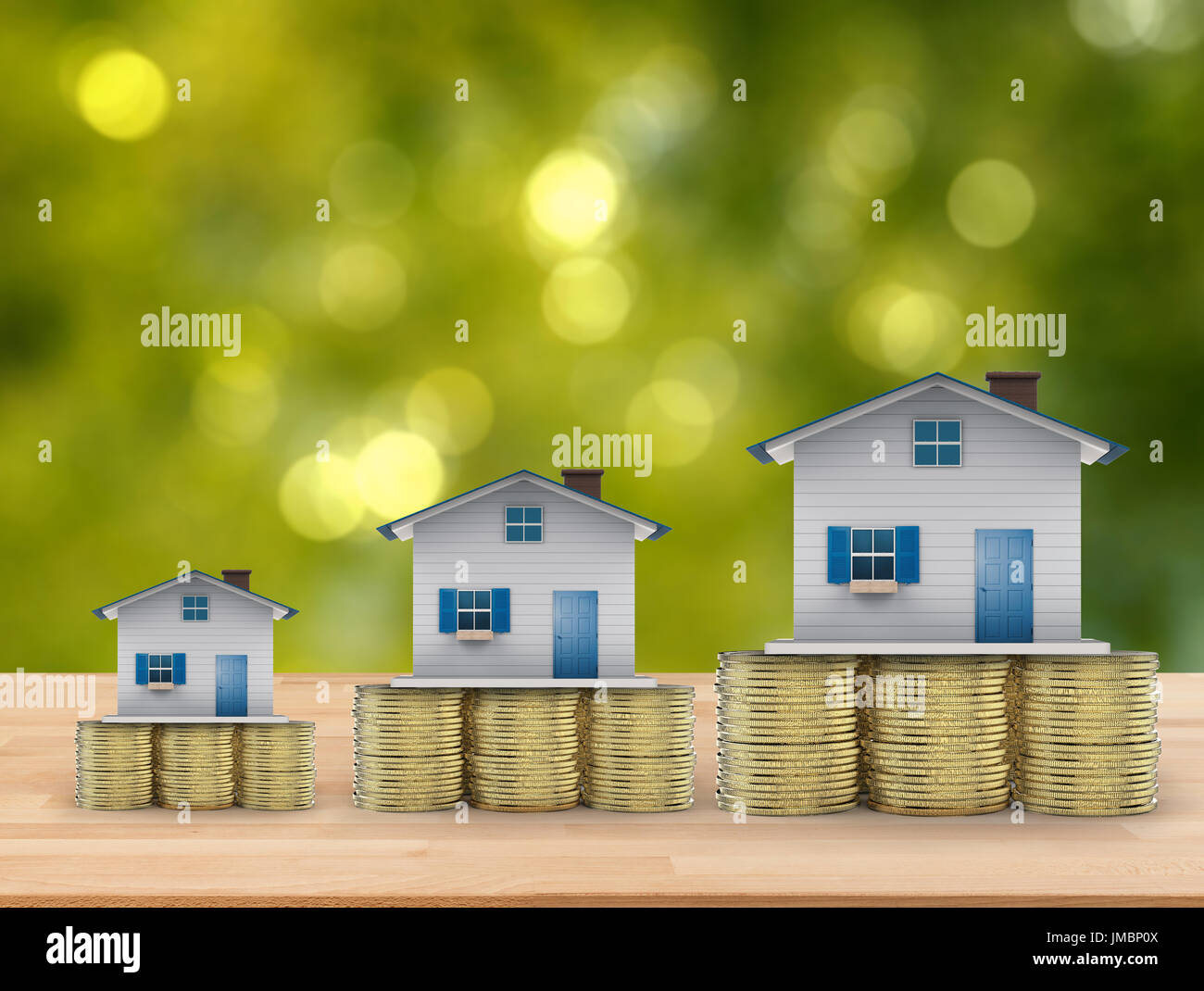 real estate investment concept with mock up houses and gold coins Stock ...