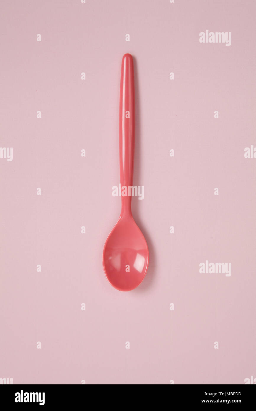 a pink spoon on a pink background. tone-on-tone photography and minimal ...