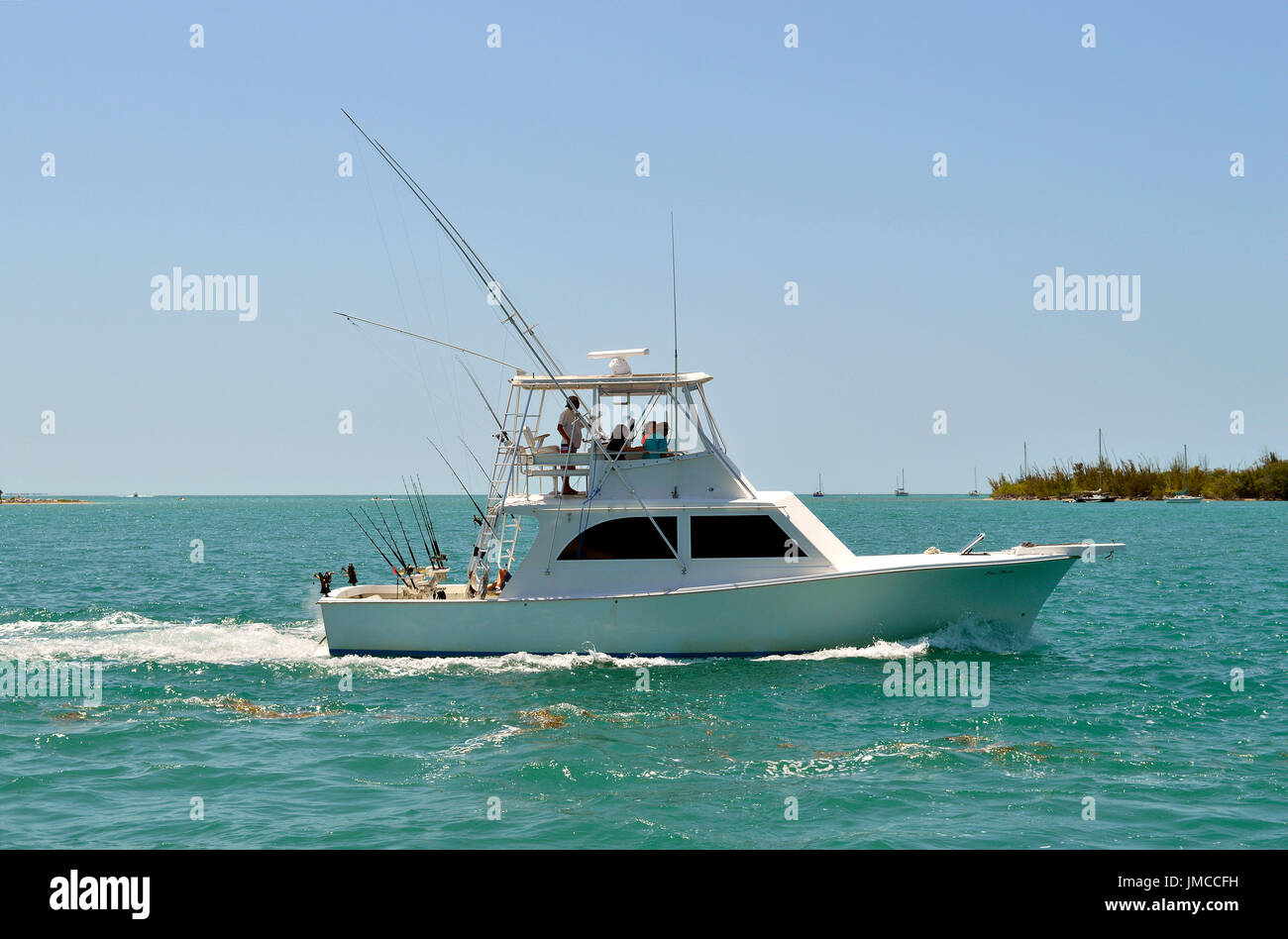 Fishing boat sailing past Sunset Key in Florida Stock Photo - Alamy