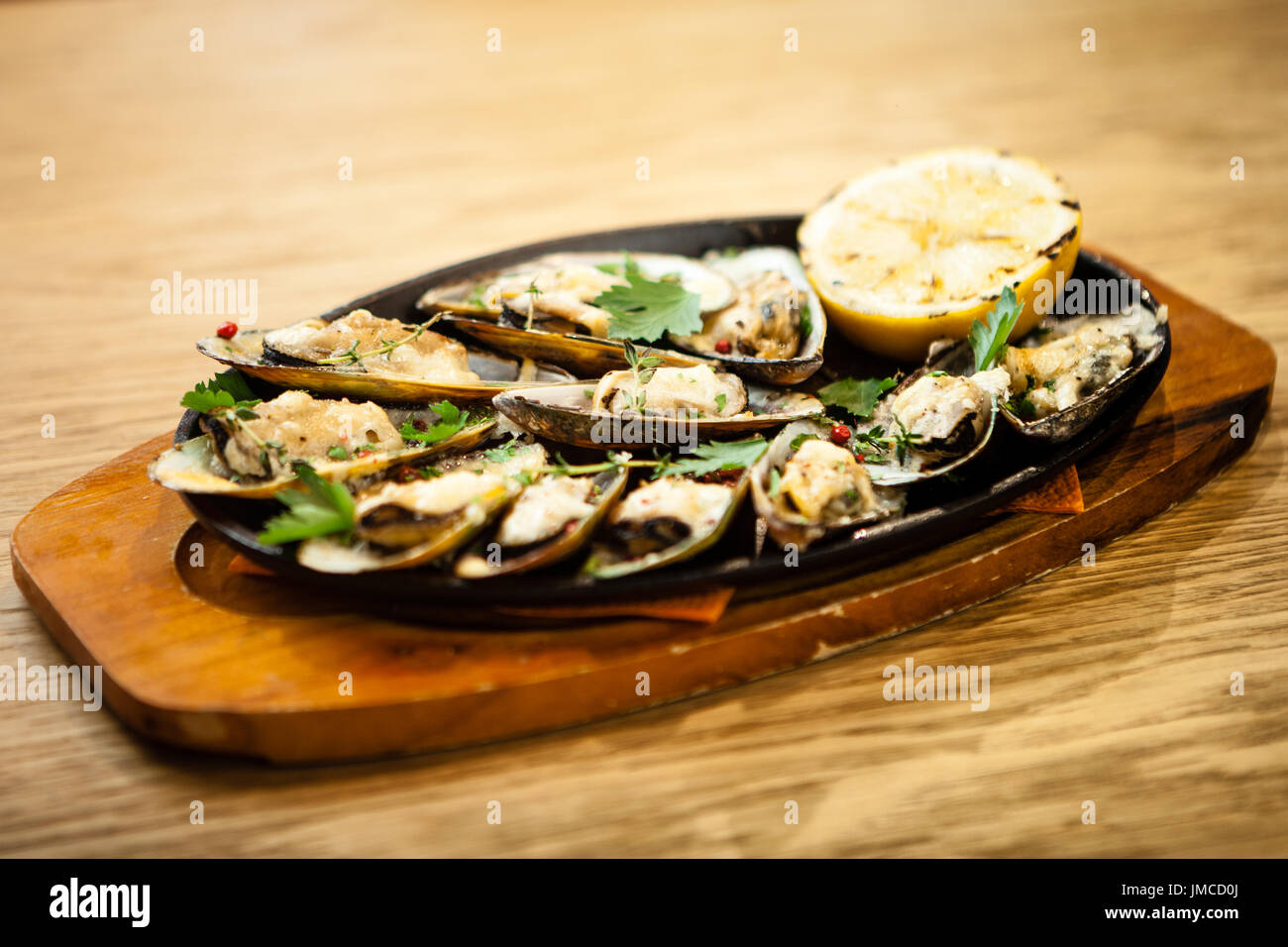 Baked mussels with cheese Stock Photo - Alamy