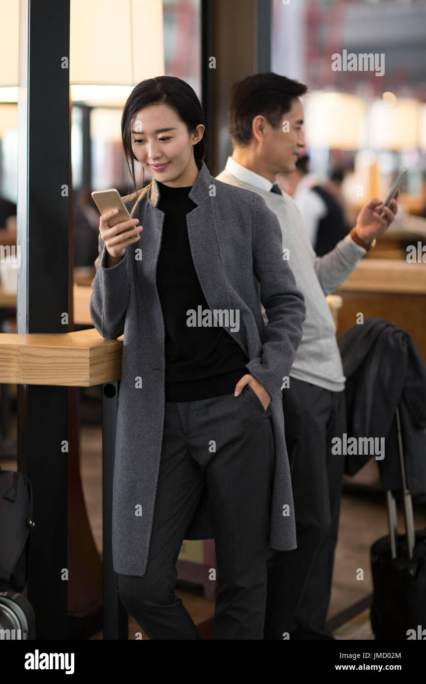 Young businesswoman airport using smart hi-res stock photography and ...