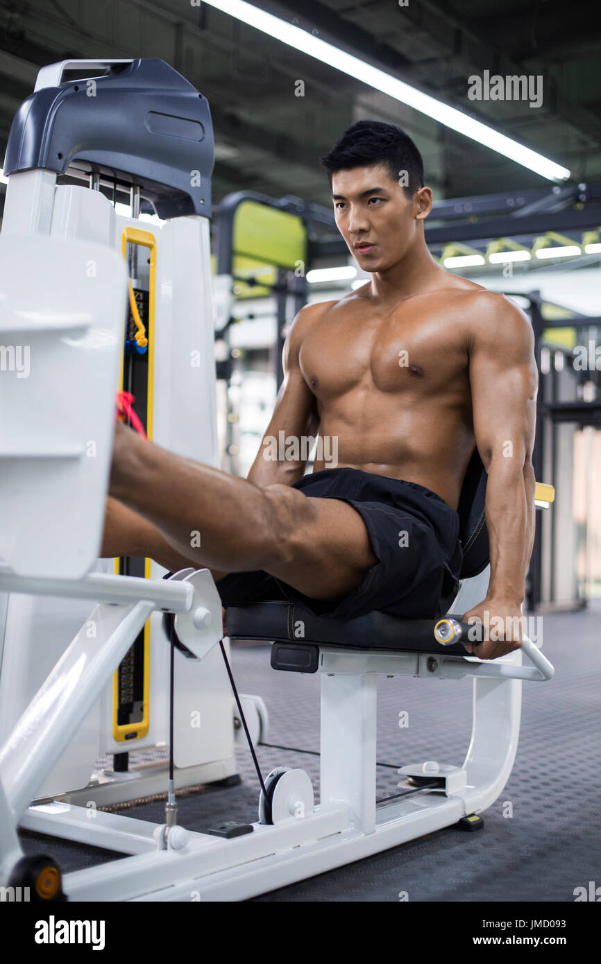 Young Chinese man exercising at gym Stock Photo - Alamy