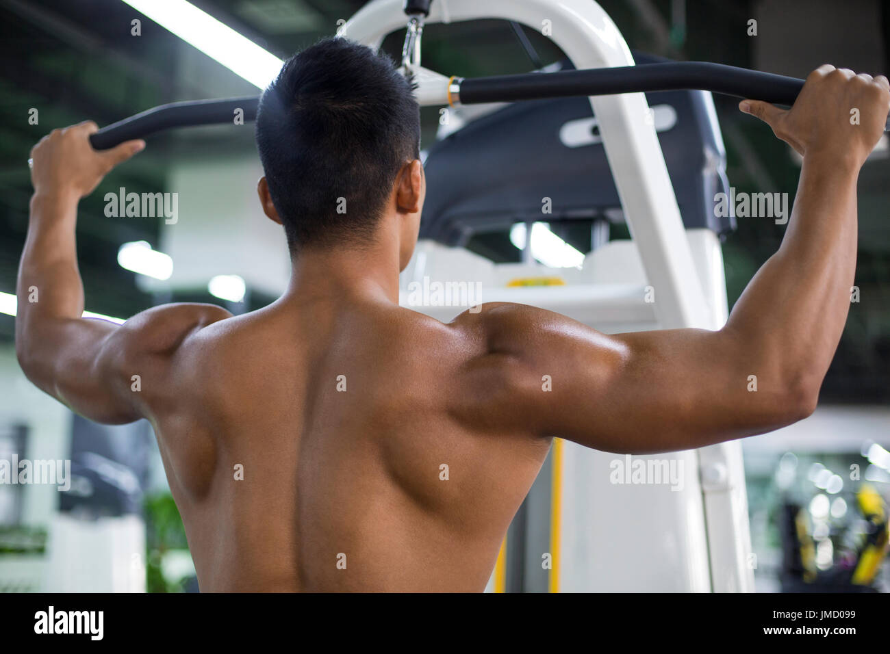 Young Chinese man exercising at gym Stock Photo - Alamy