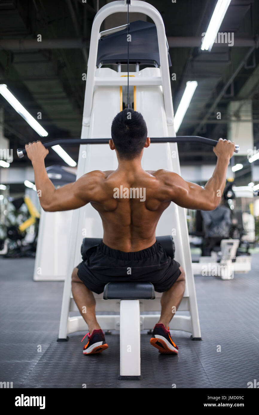 Young Chinese man exercising at gym Stock Photo - Alamy