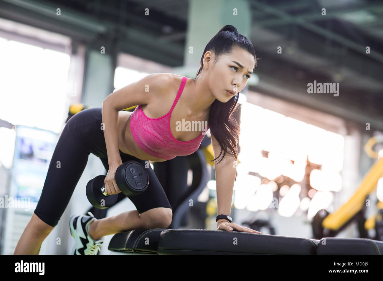 Young Chinese woman exercising at gym Stock Photo - Alamy