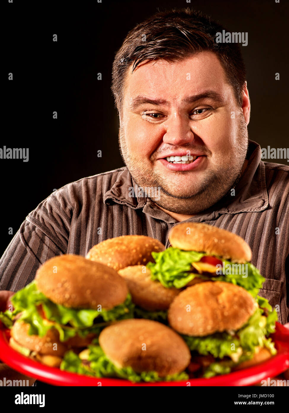 Fat man eating fast food hamberger and carries treat for friends on ...