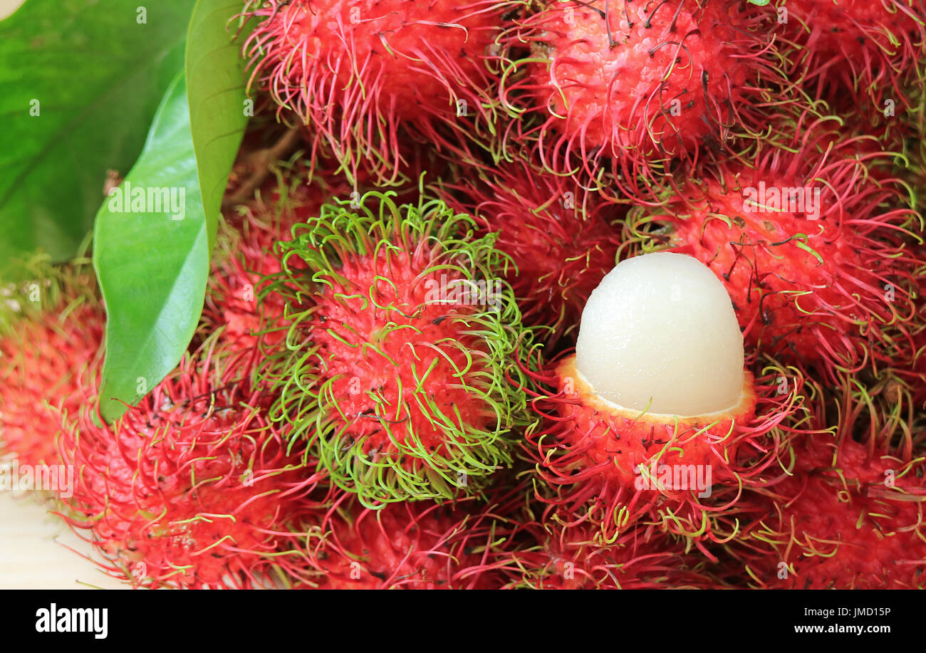 Bunch of Vibrant Color Ripe Rambutan Whole Fruits and Opened to Show ...
