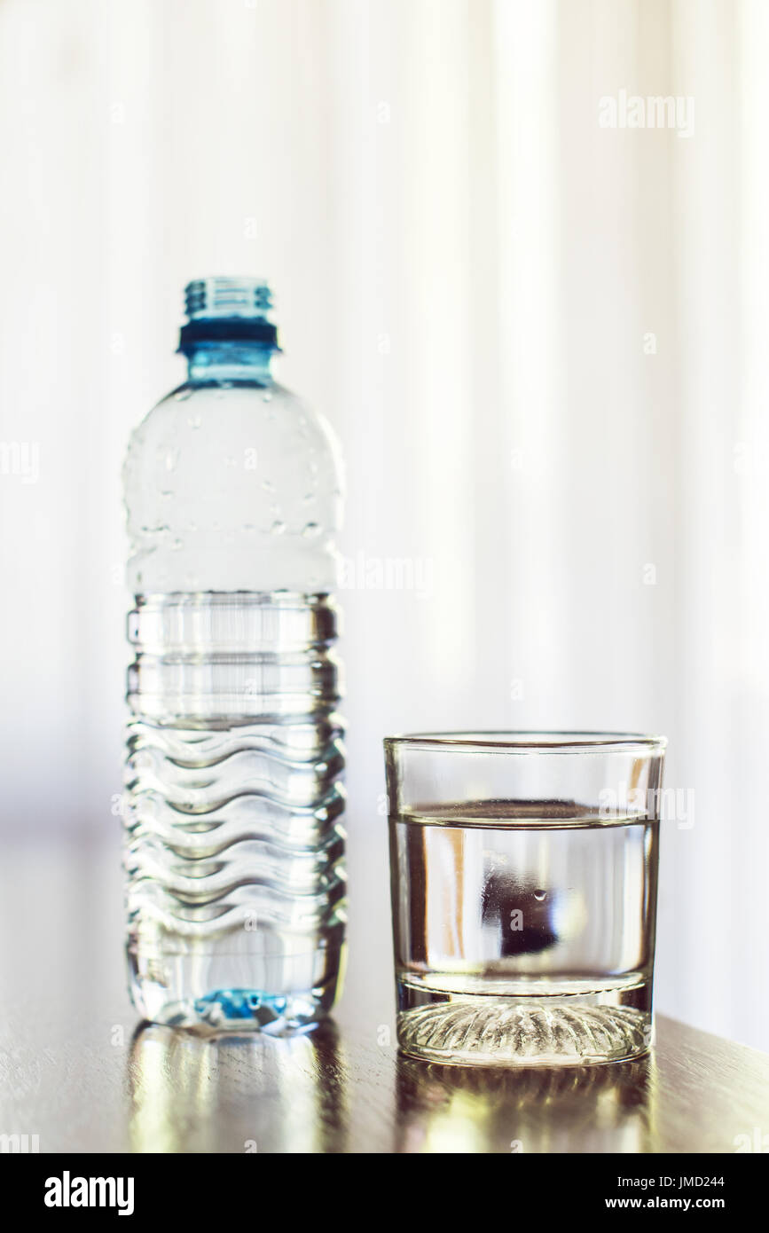 Glass of water and a plastic bottle Stock Photo - Alamy